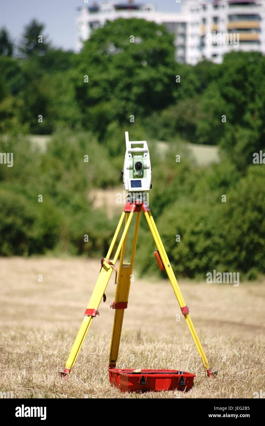 A leveling device on a three-armed tripod for landscape surveying Stock ...