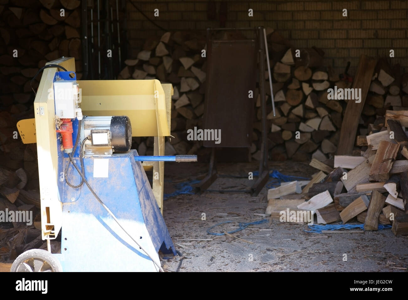 The front view of a wood saw in a room with firewood Stock Photo - Alamy