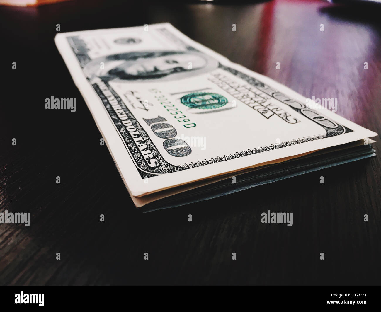 One hundred dollars on table hi-res stock photography and images - Alamy