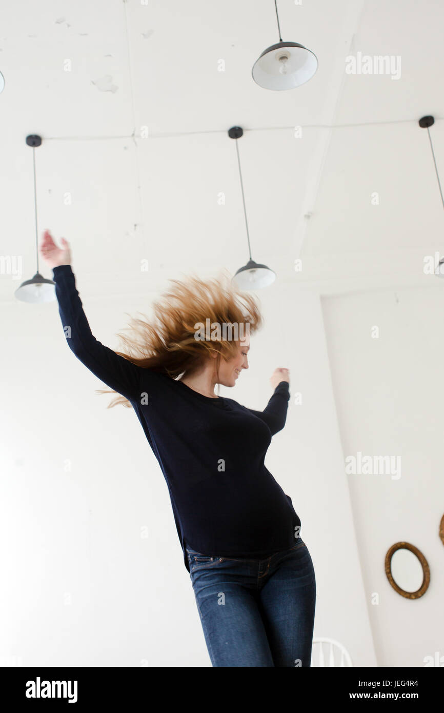 Happy woman jumping in excitement Stock Photo - Alamy