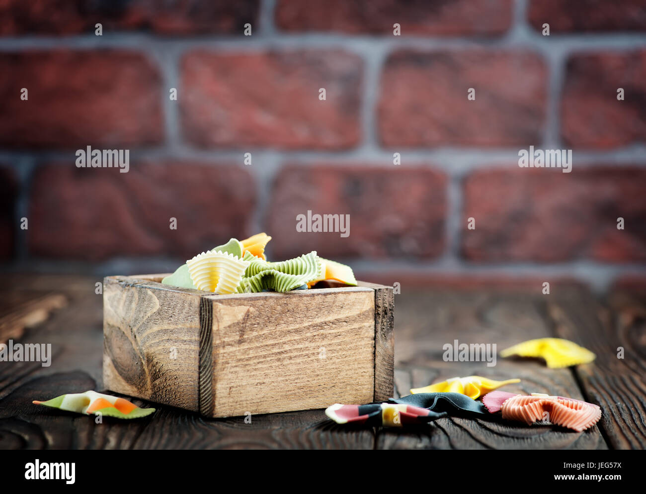 color raw pasta in wooden box and on a table Stock Photo - Alamy