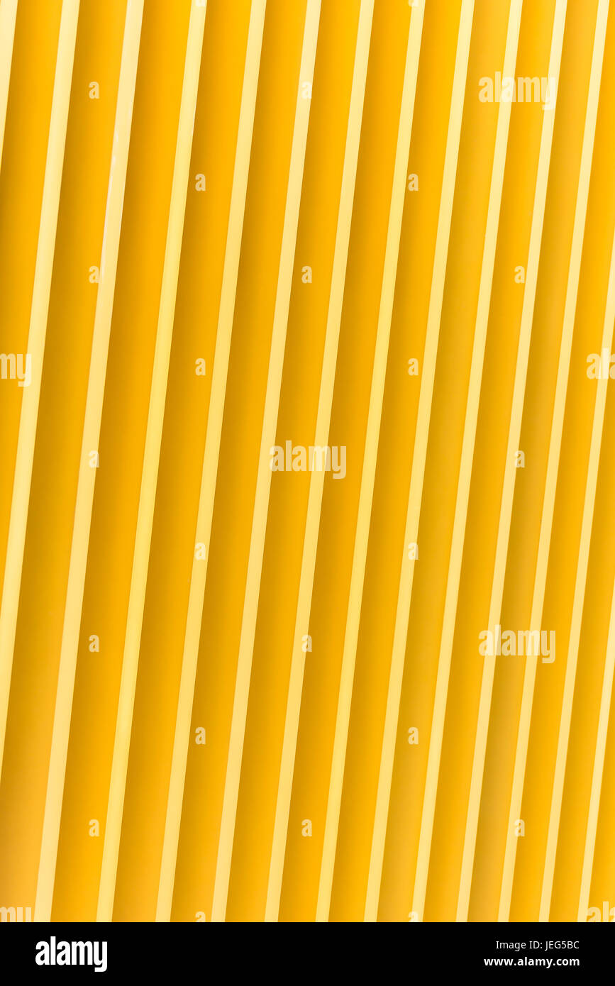 Detail of bright yellow metal building facade. For background Stock ...