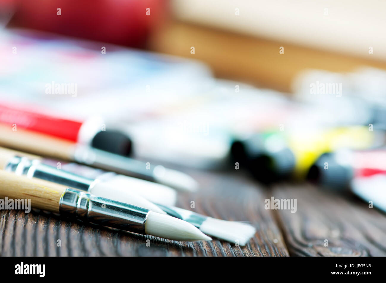 color paint and brushes on a table Stock Photo - Alamy