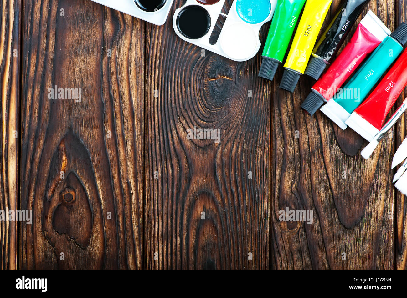 color paint and brushes on a table Stock Photo - Alamy