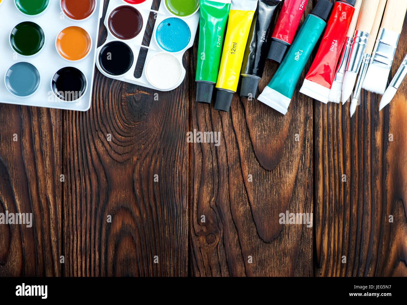 color paint and brushes on a table Stock Photo - Alamy