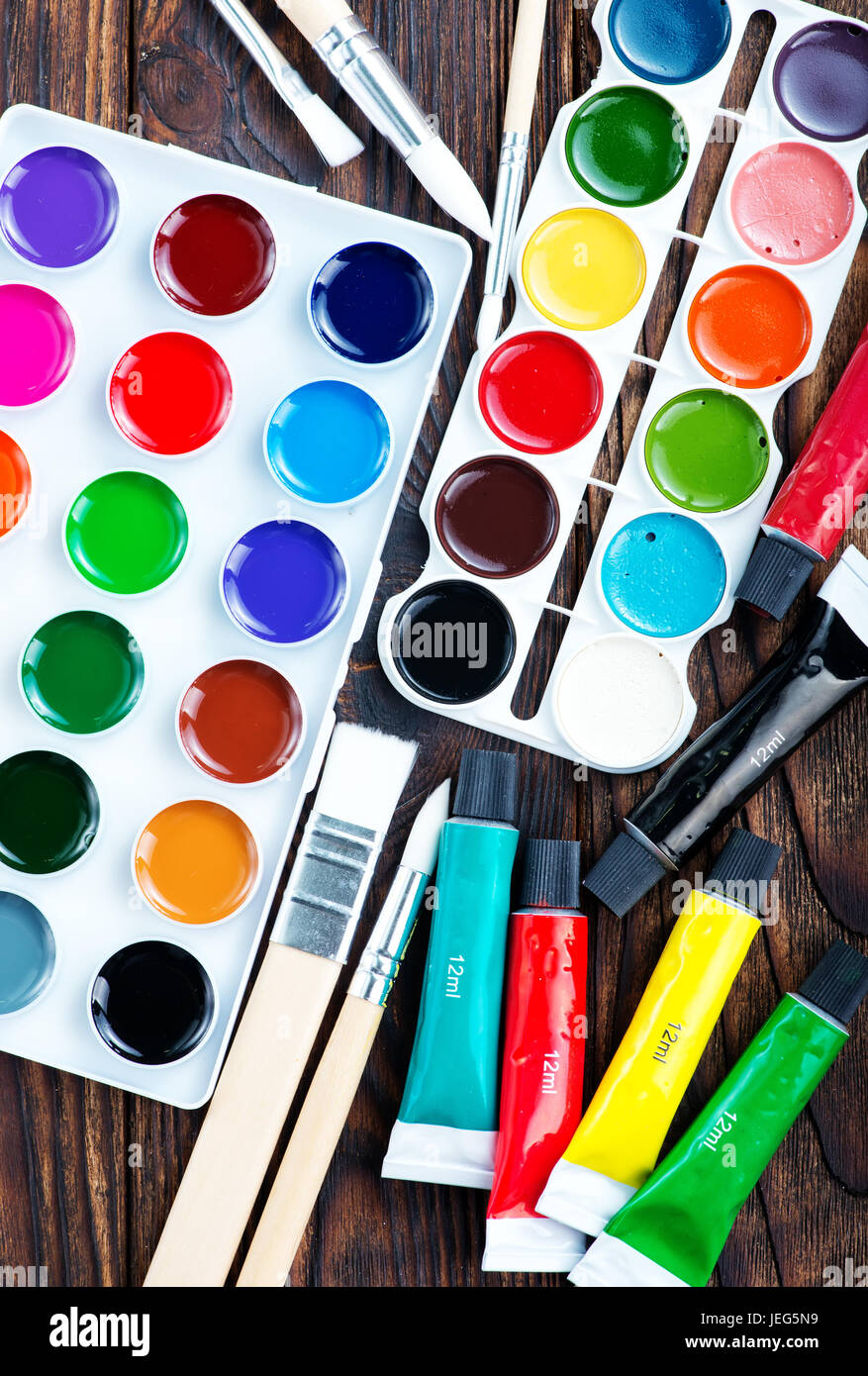 color paint and brushes on a table Stock Photo - Alamy