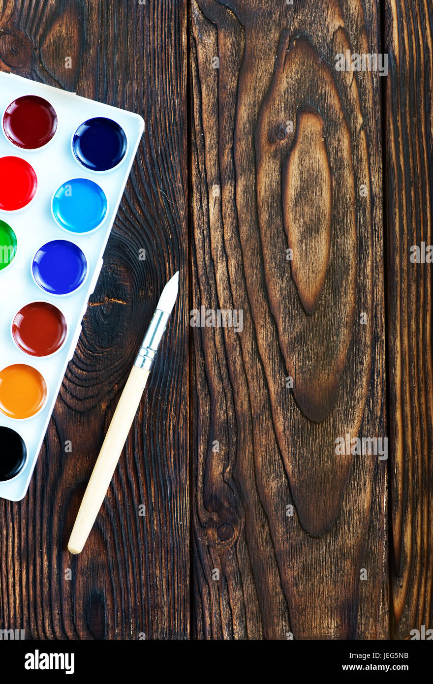 color paint and brushes on a table Stock Photo - Alamy