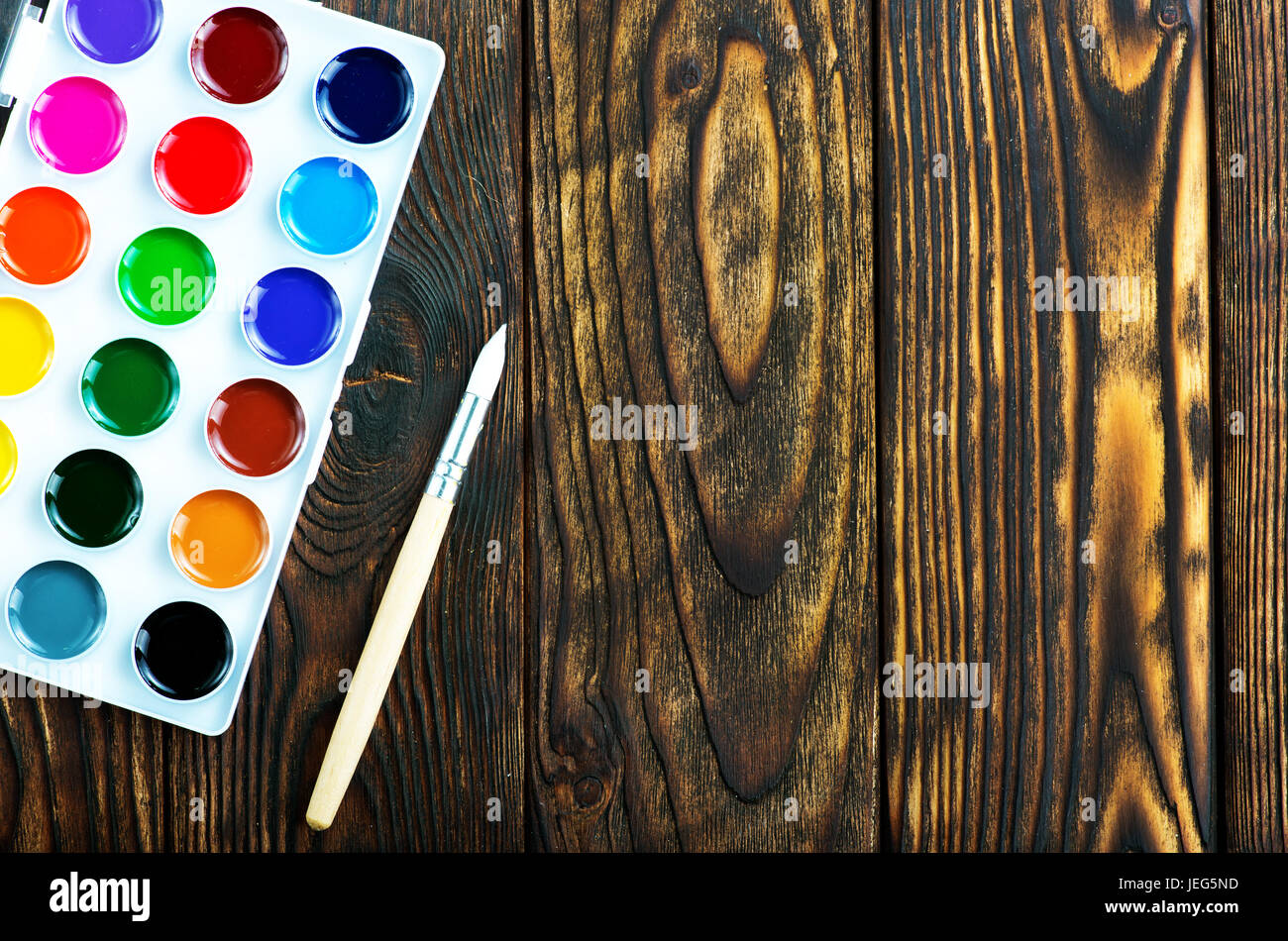 color paint and brushes on a table Stock Photo - Alamy