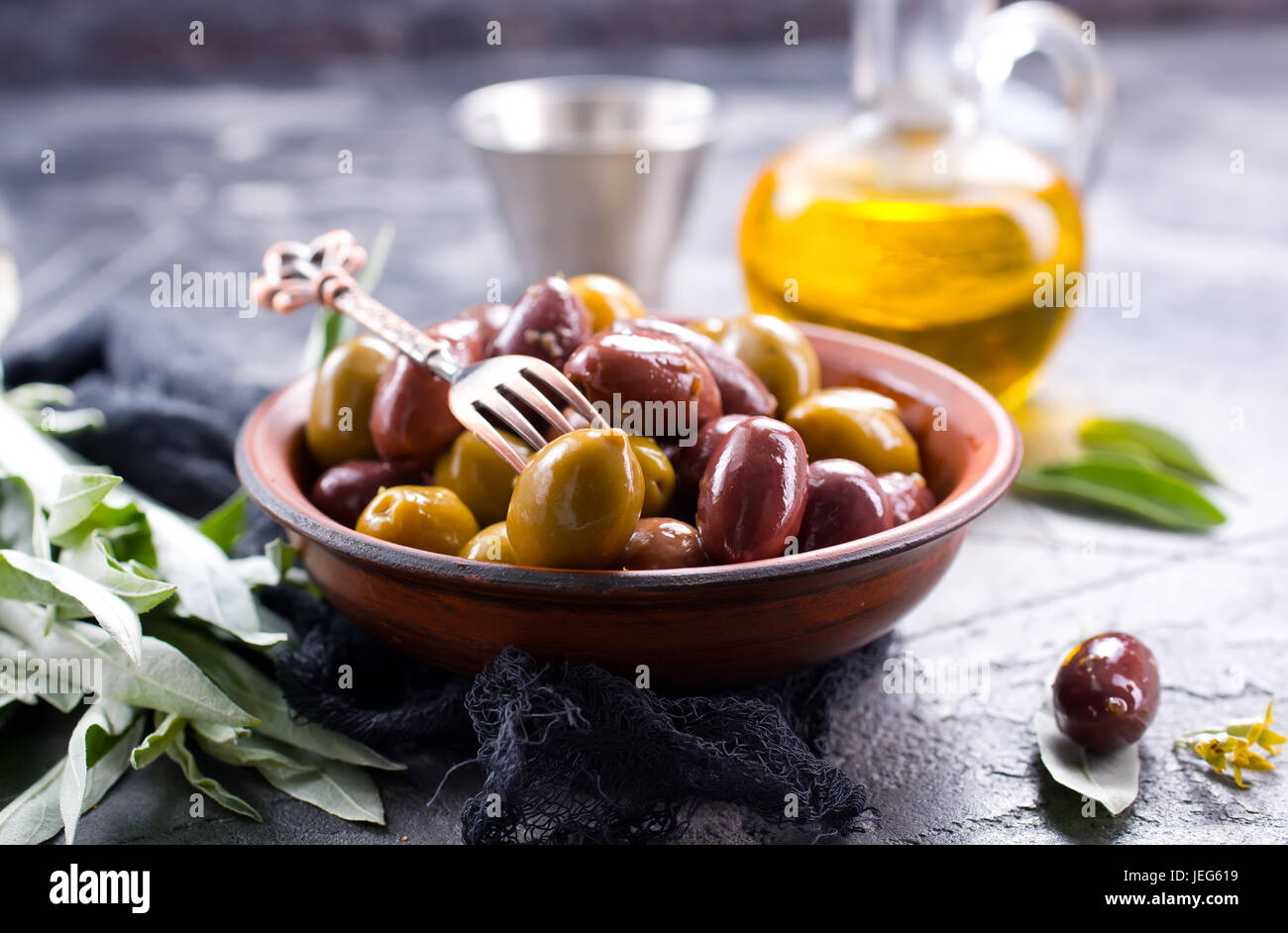 olives in bowl and on a table Stock Photo - Alamy