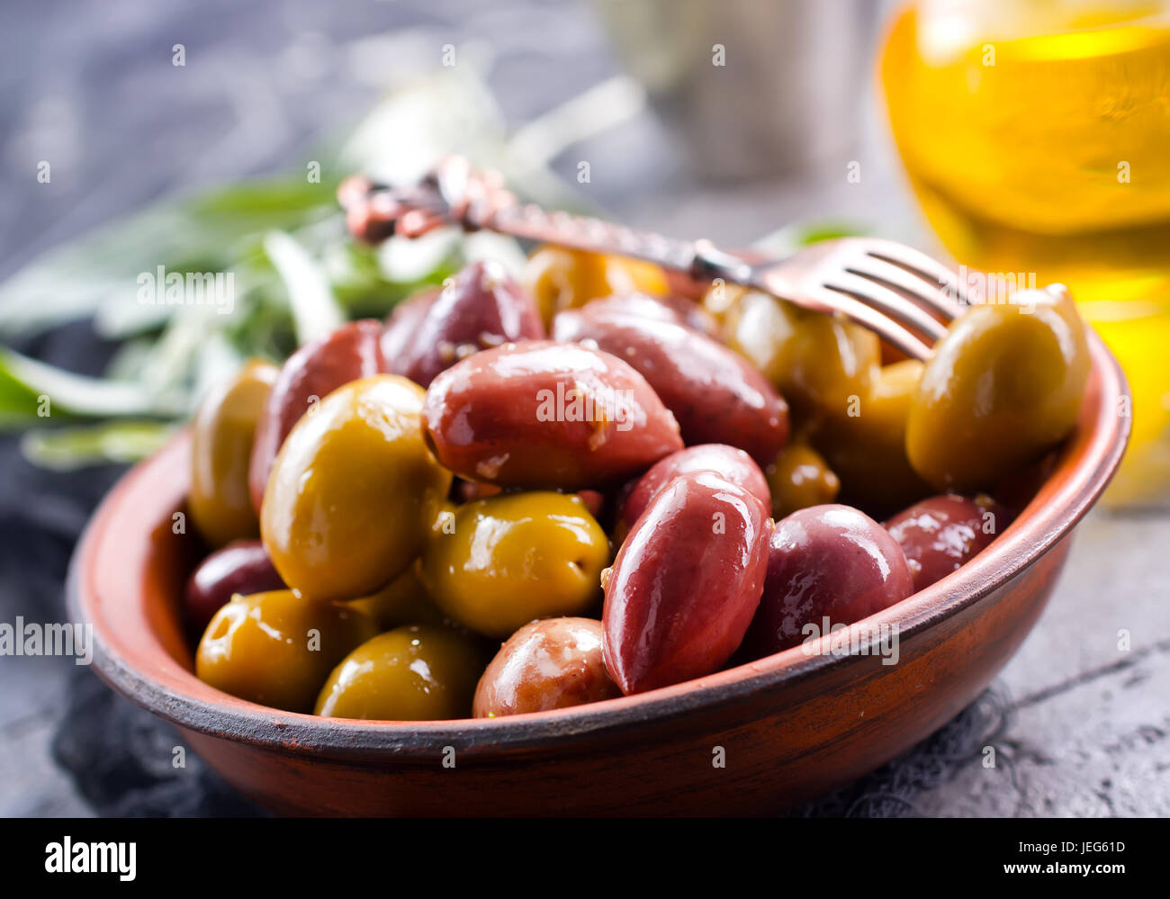 olives in bowl and on a table Stock Photo - Alamy