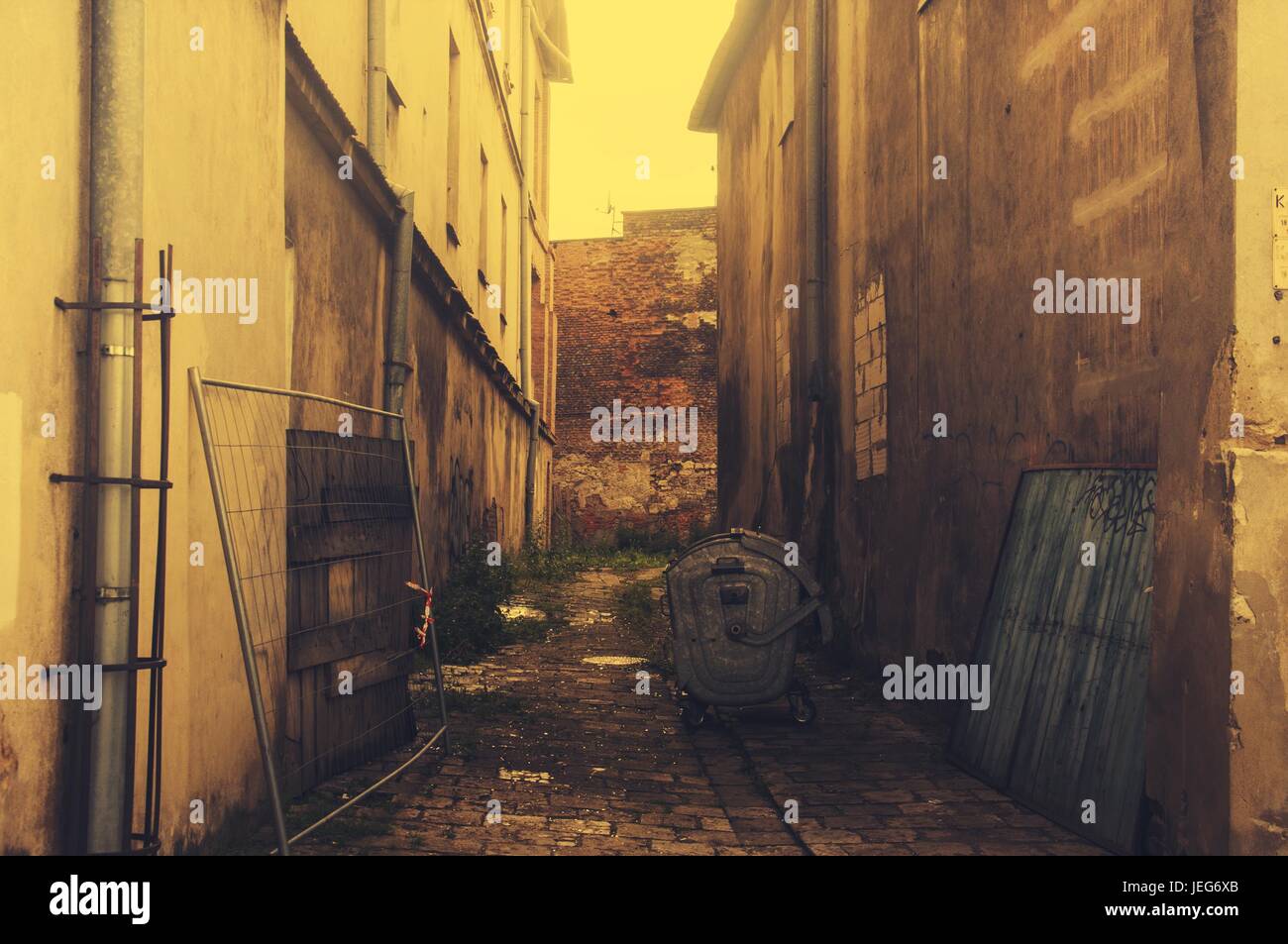 backyard alley in old town with garbage metal bins Stock Photo - Alamy