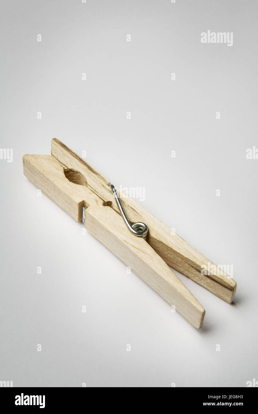 single wooden clothes peg on white background Stock Photo - Alamy