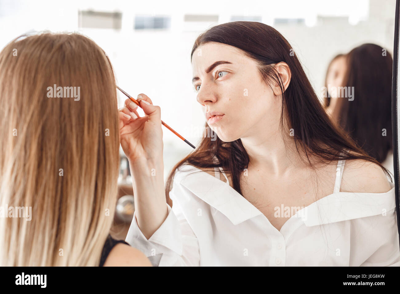 Portrait of a master in a beauty salon during the procedure Stock Photo ...