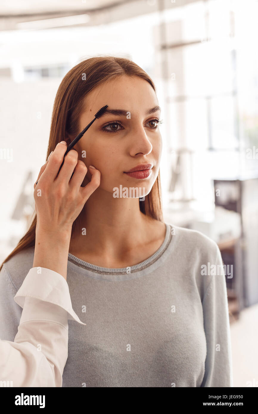 Portrait of a beautiful model during an eyebrow correction procedure ...