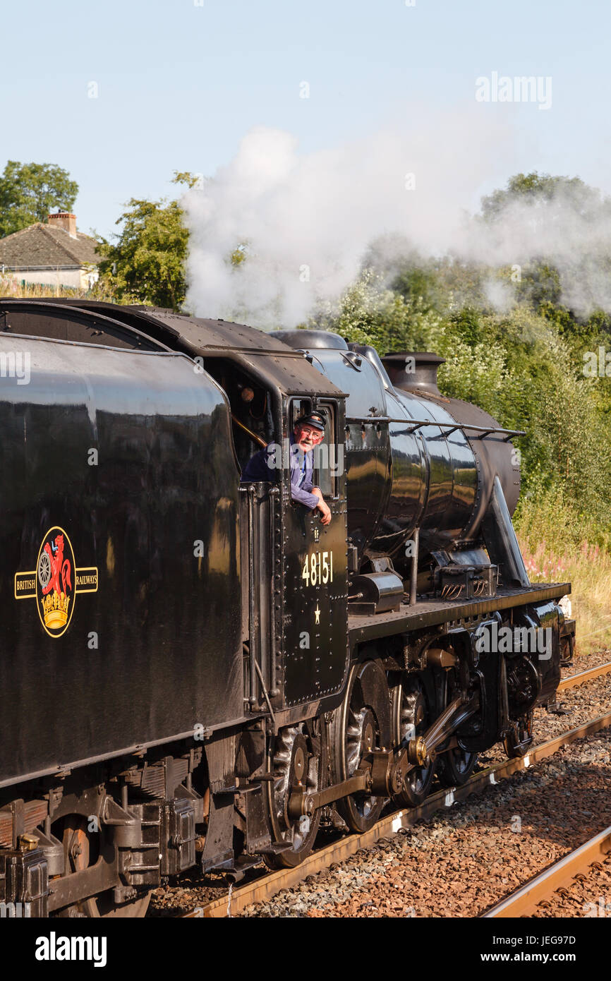 The train driver aboard a Stanier Class 8F steam locomotive looks back ...