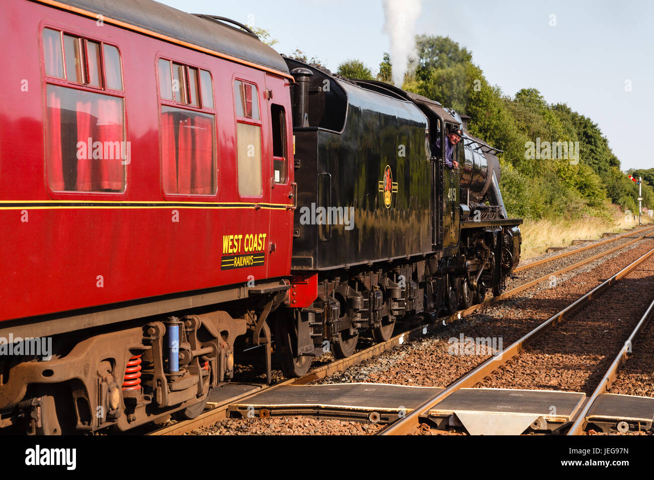 The train driver aboard a Stanier Class 8F steam locomotive looks back ...