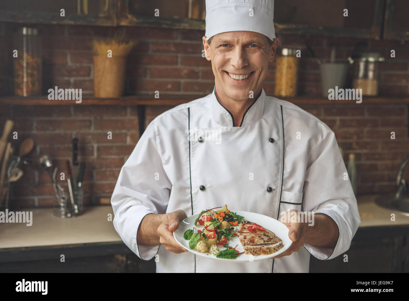 Mature male professional chef cooking meal indoors finished Stock Photo ...