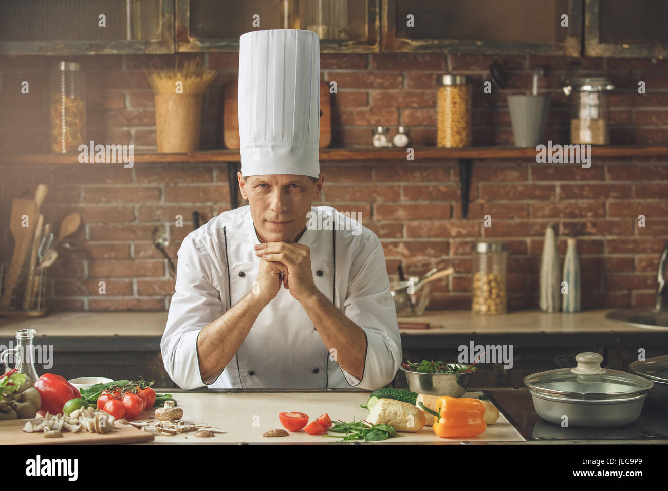 Mature male professional chef cooking meal indoors Stock Photo - Alamy