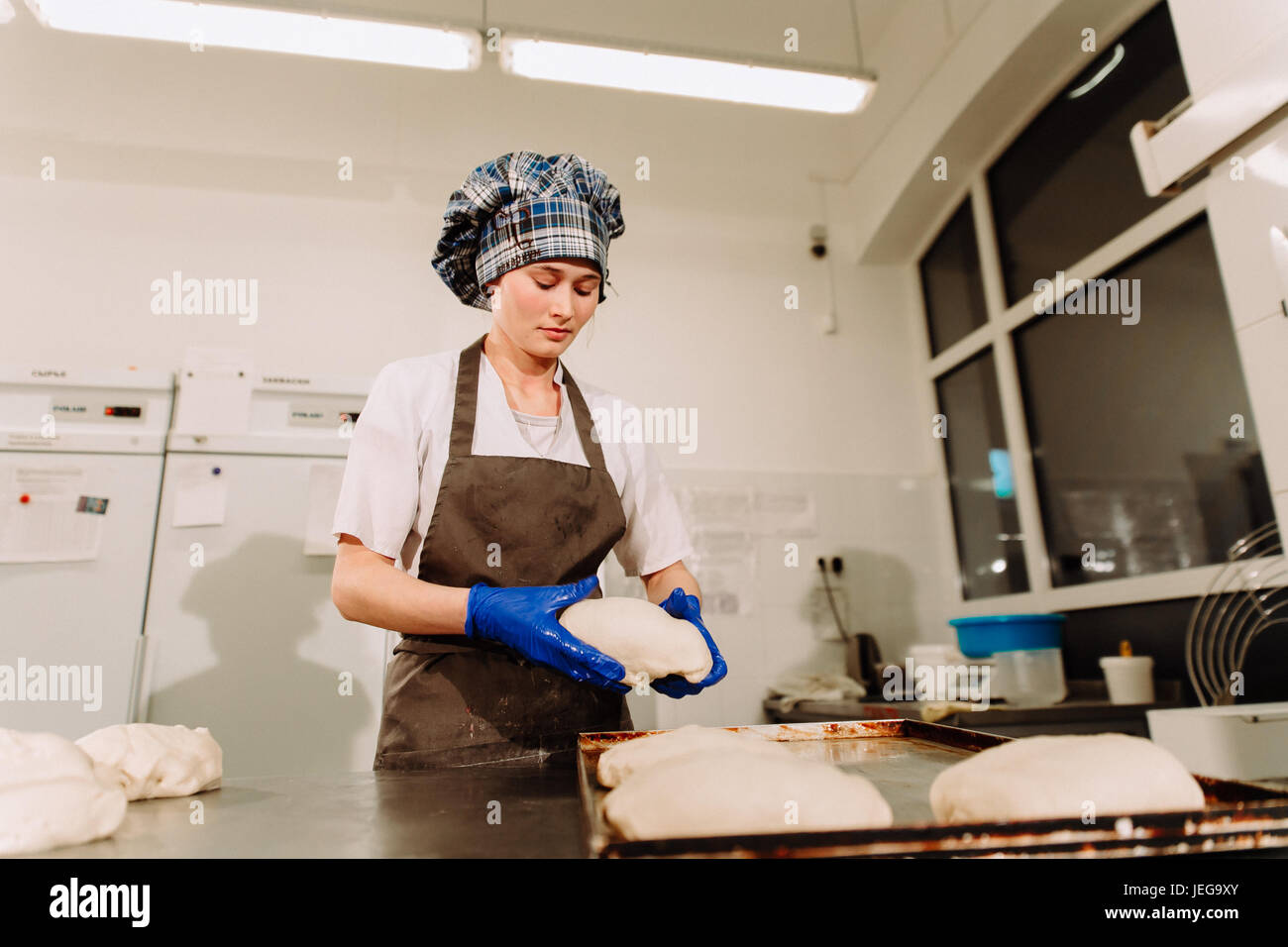 Baker preparing dough for bread Stock Photo - Alamy