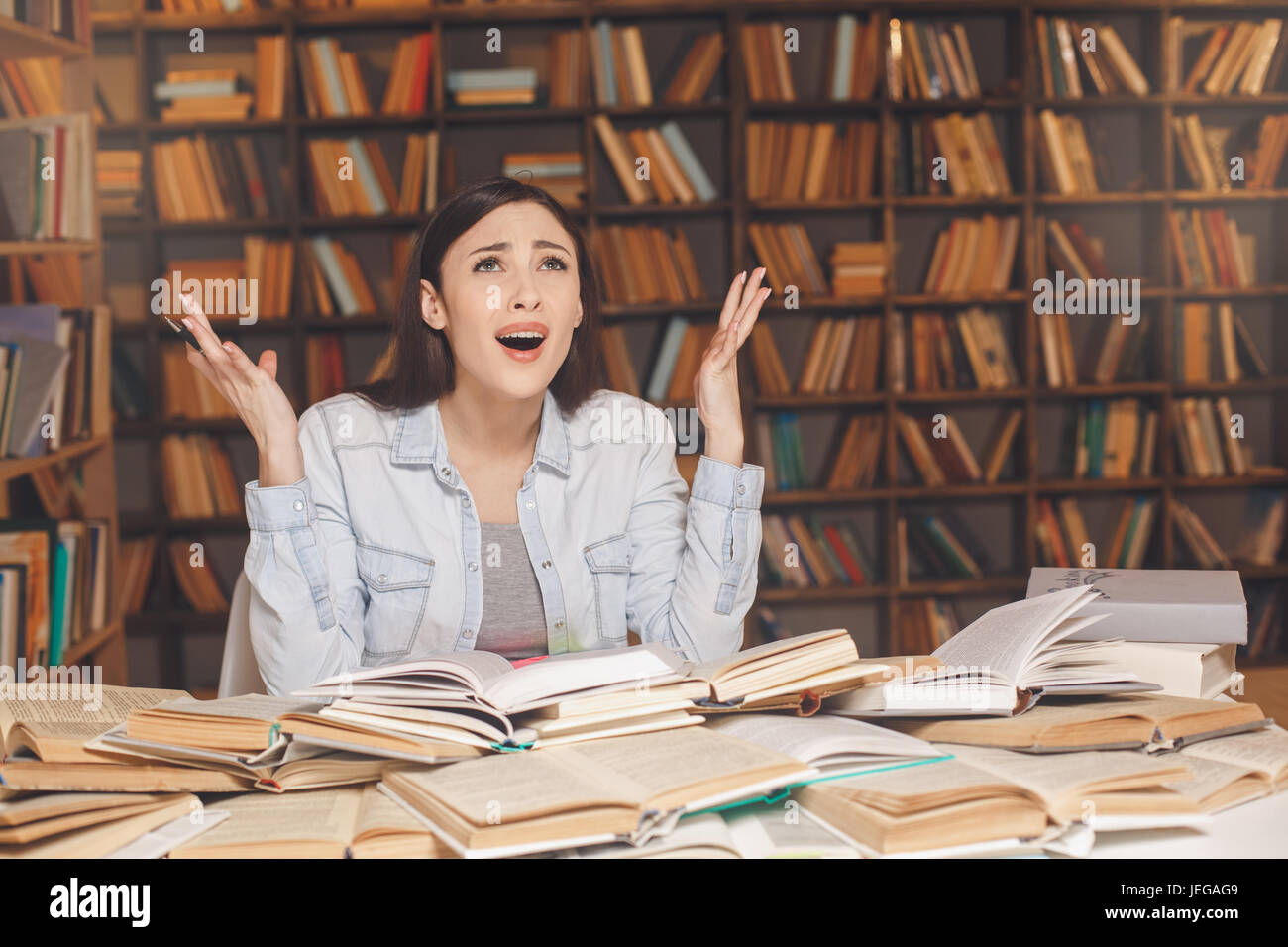 Young female study in the library upset Stock Photo - Alamy