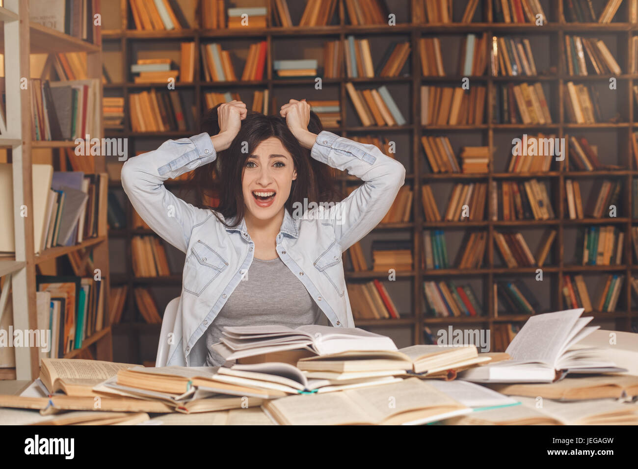 Young female study in the library upset Stock Photo - Alamy