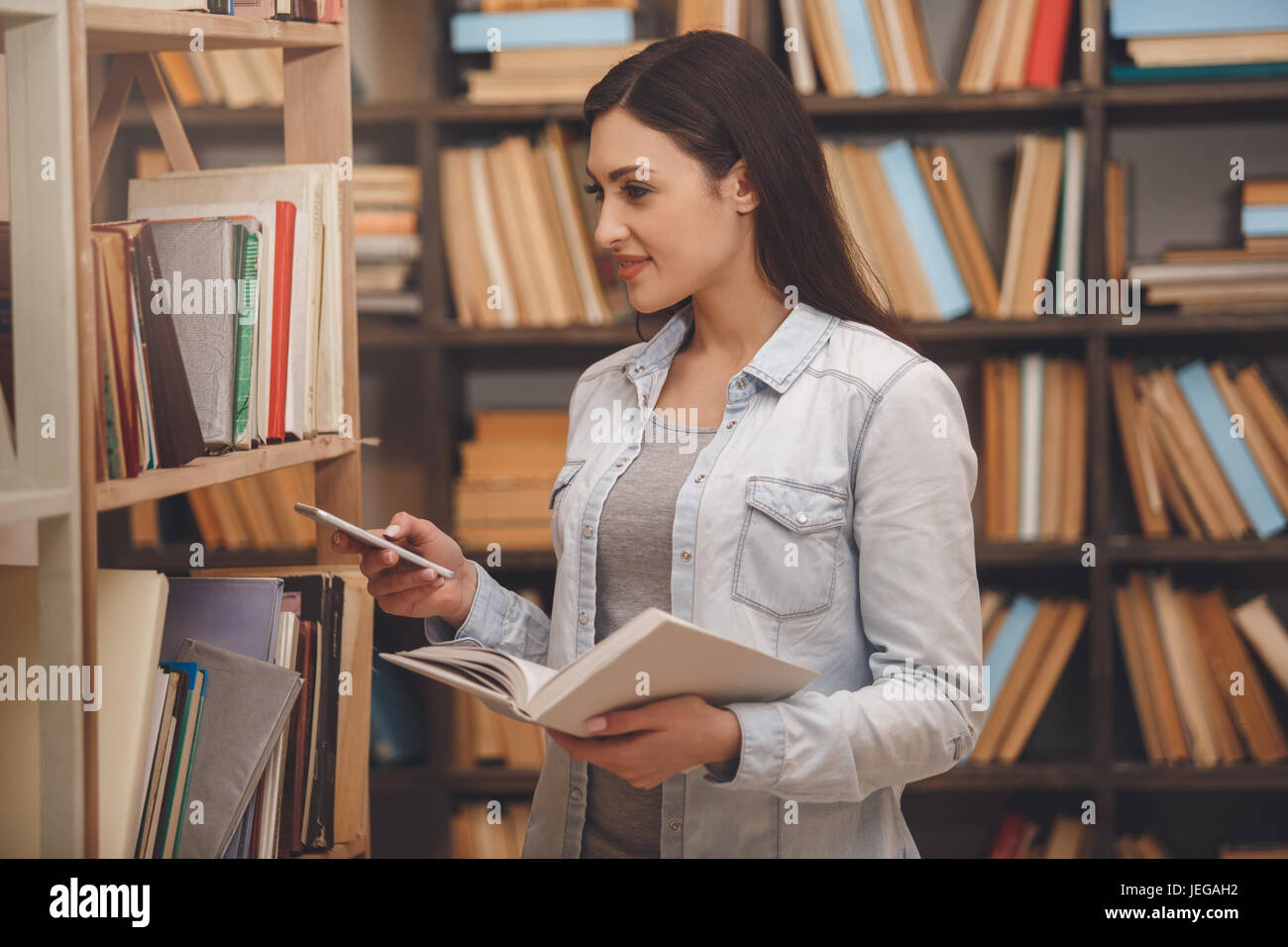 Young female study in the library searching book Stock Photo - Alamy