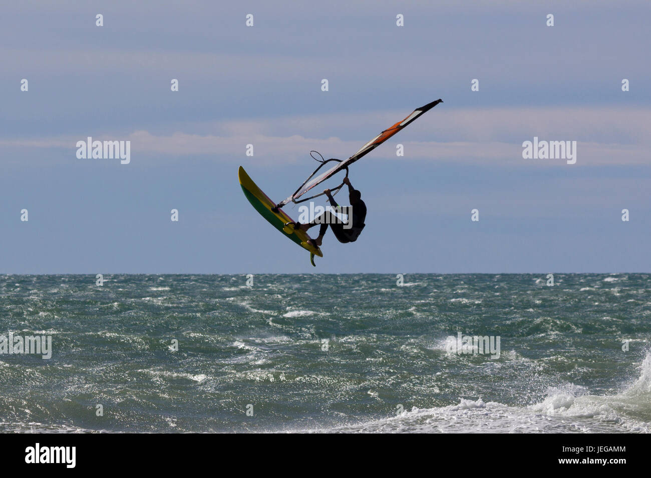 Windsurf acrobatic jump in the sea Stock Photo - Alamy