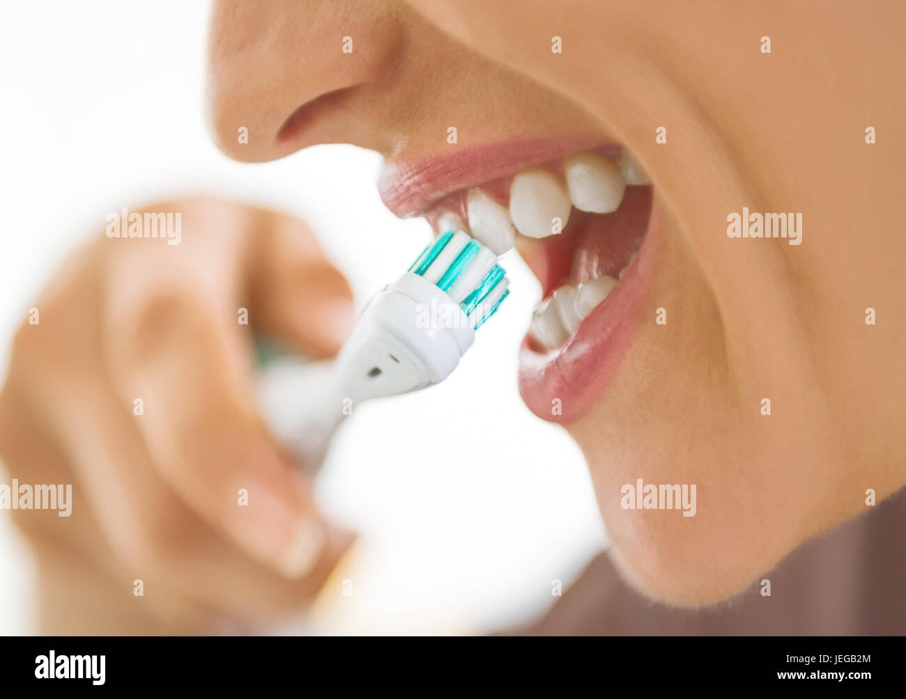 Closeup on happy young woman brushing teeth Stock Photo - Alamy
