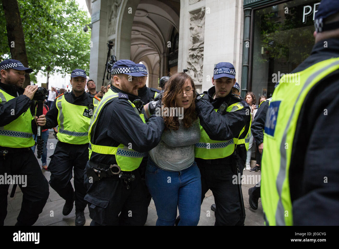 London, UK. 24th June, 2017. Police officers arrest a woman among anti ...