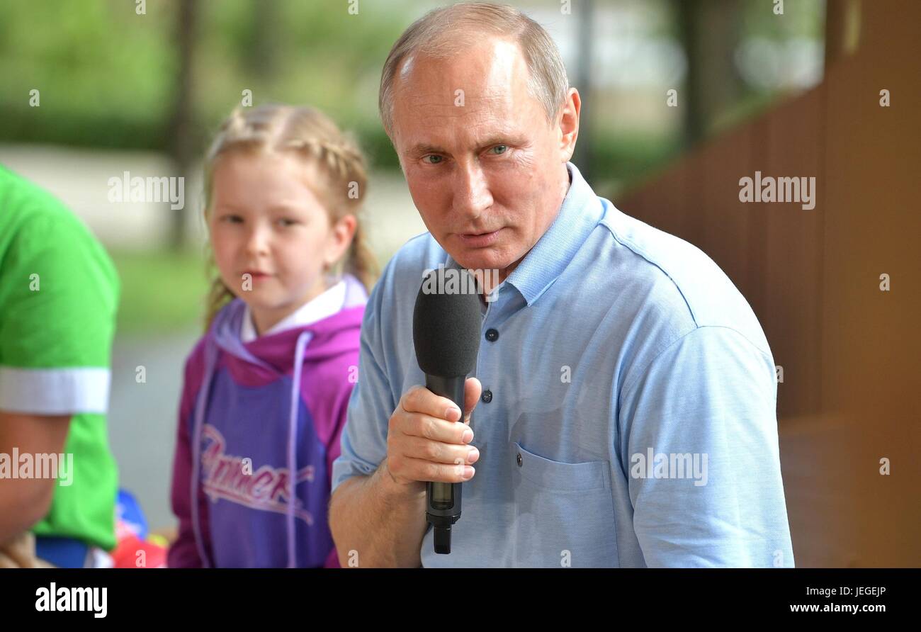 Russian President Vladimir Putin speaks with children during a tour of ...