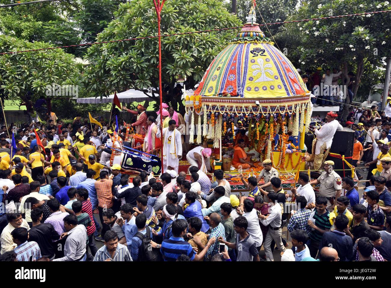 NEW DELHI, INDIA - JUNE 25: Devotees take part in pulling a chariot of ...