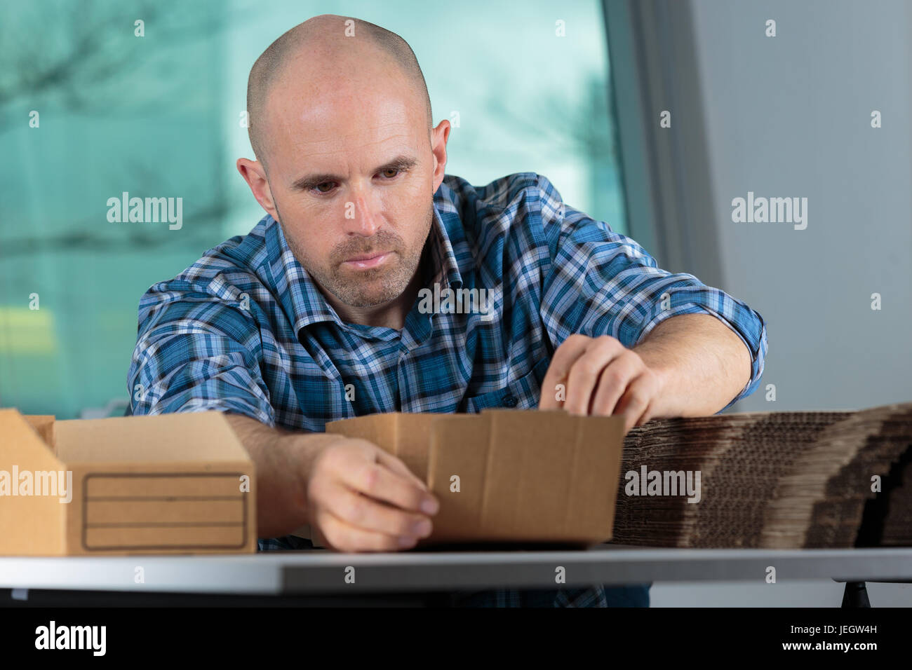 delivery man counting boxes Stock Photo - Alamy