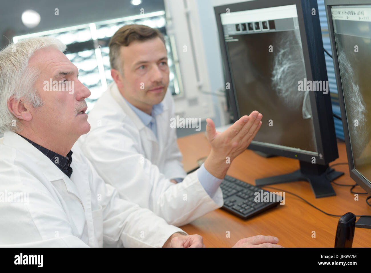Medical workers looking at results on computer screen Stock Photo - Alamy