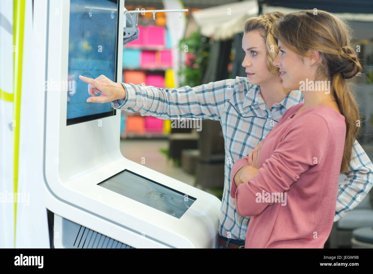 women standing front big digital screen Stock Photo - Alamy