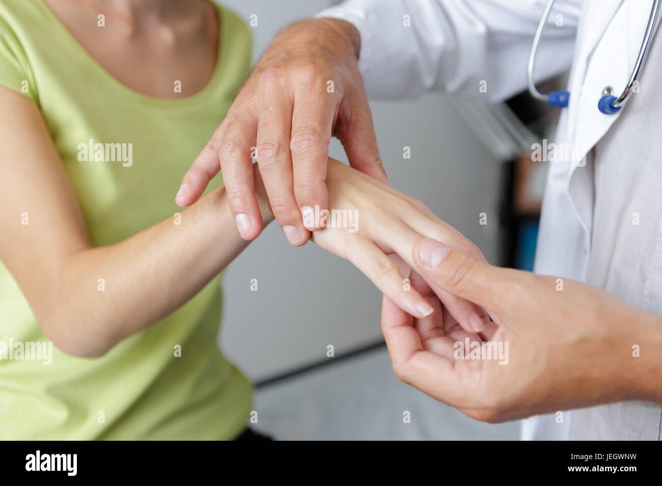 doctor checking fingers and wrist of a patient Stock Photo - Alamy