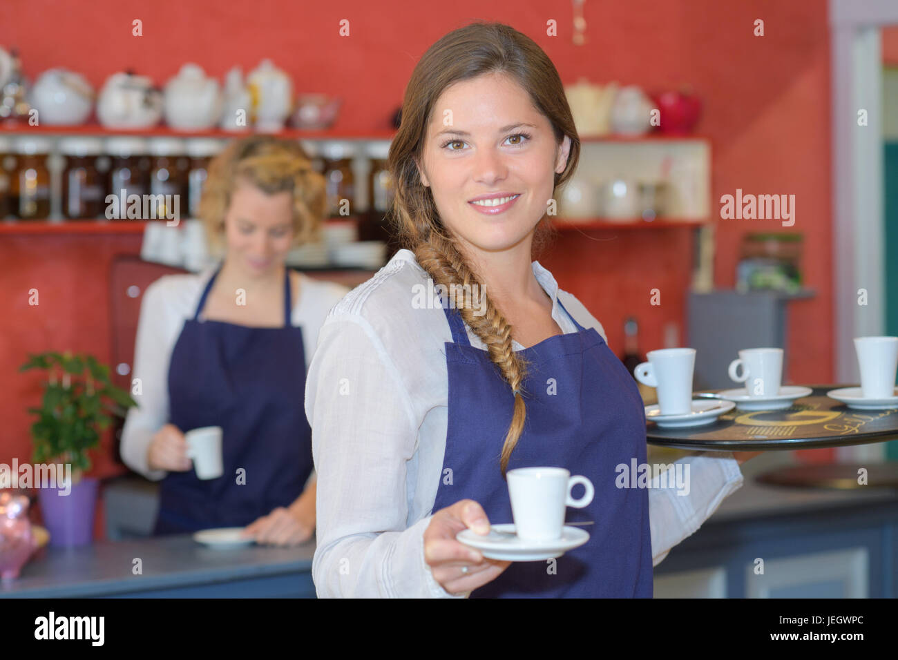 pretty waitresses behind the counter working at the coffee shop Stock ...