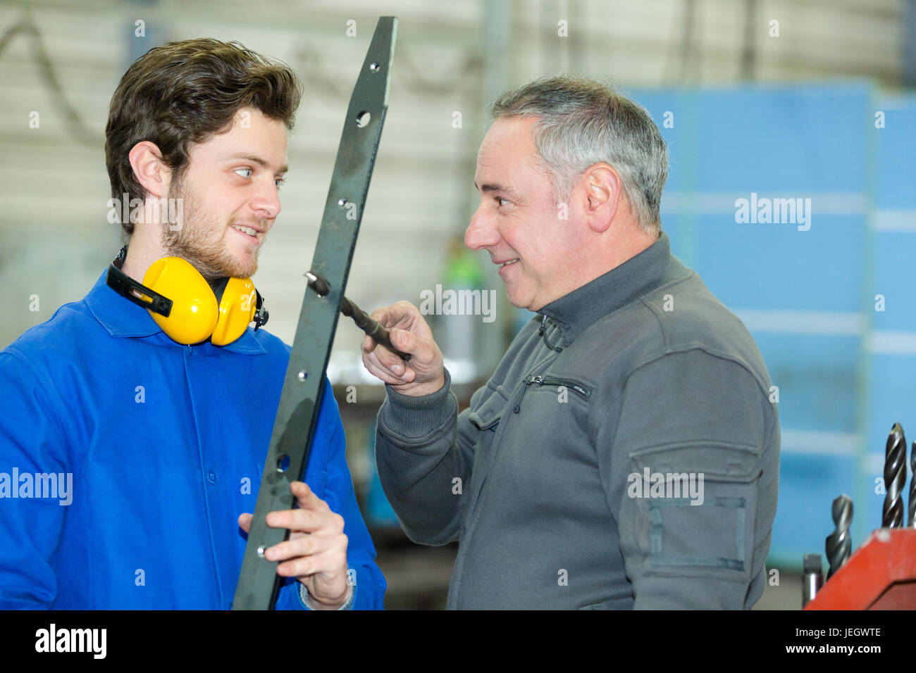 supervisor checking apprentices work Stock Photo - Alamy