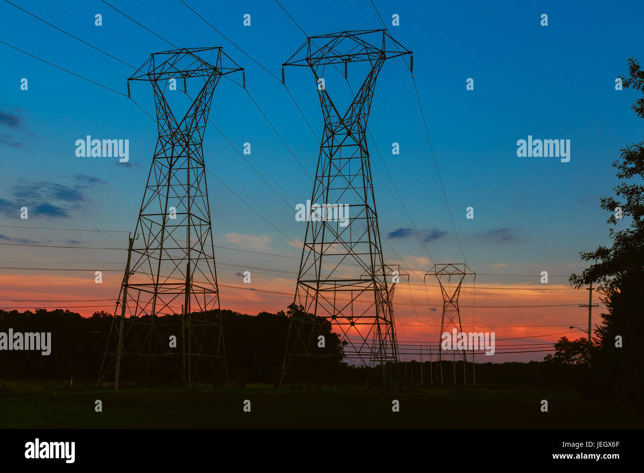 Electricity cable communication towers on sunset stretching Stock Photo ...