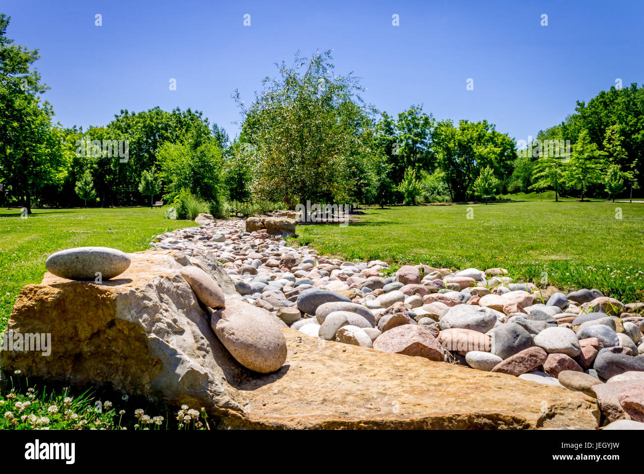 Long rock creek meandering through the park Stock Photo - Alamy