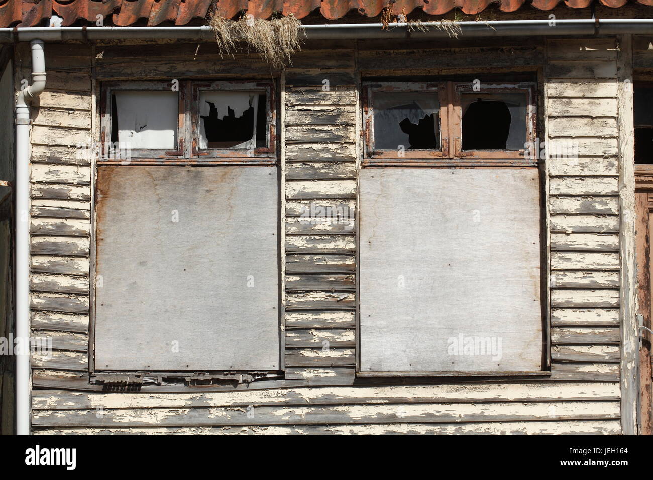 old windows on an old condemned wooden house Stock Photo - Alamy
