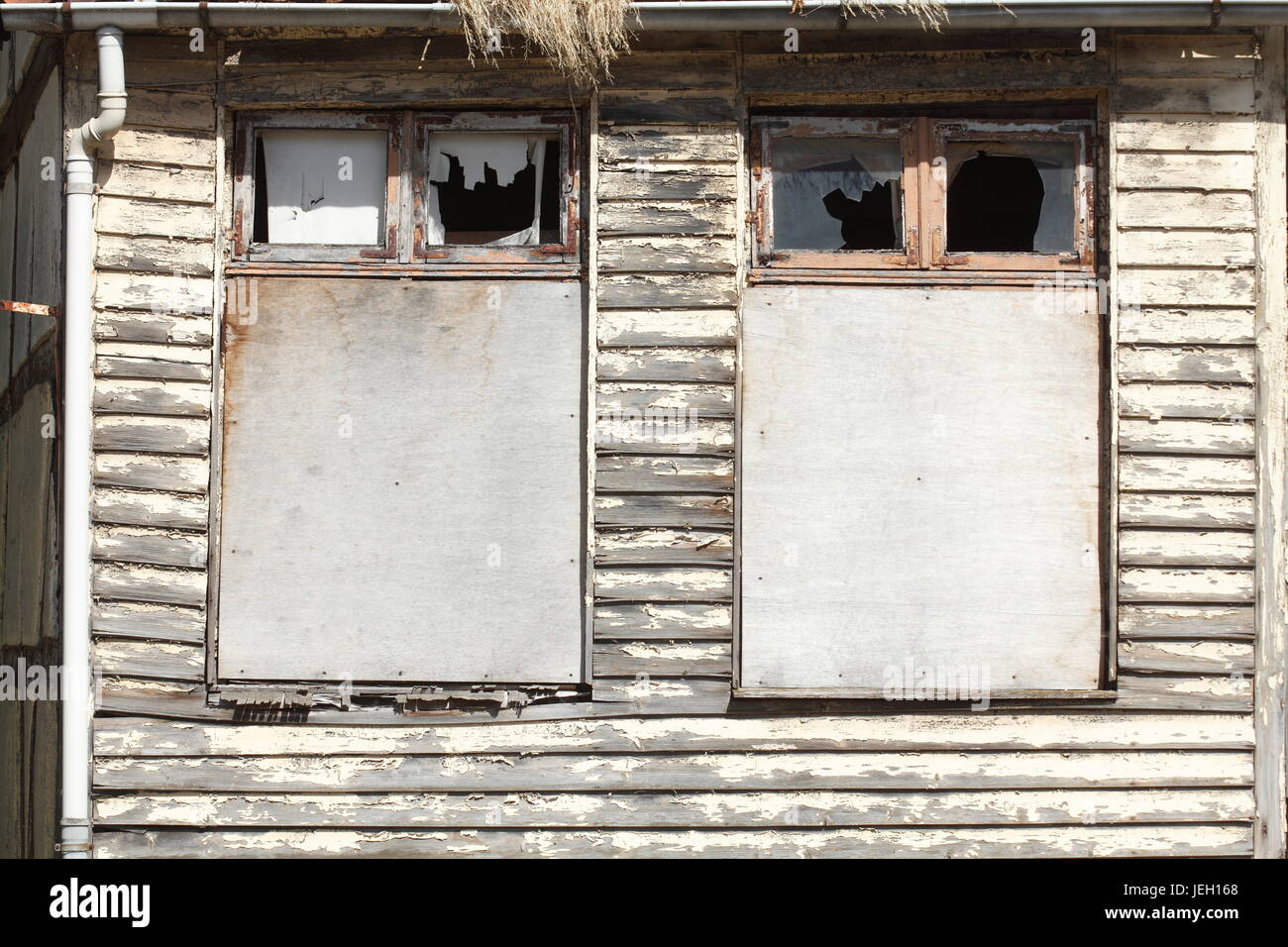old windows on an old condemned wooden house Stock Photo - Alamy
