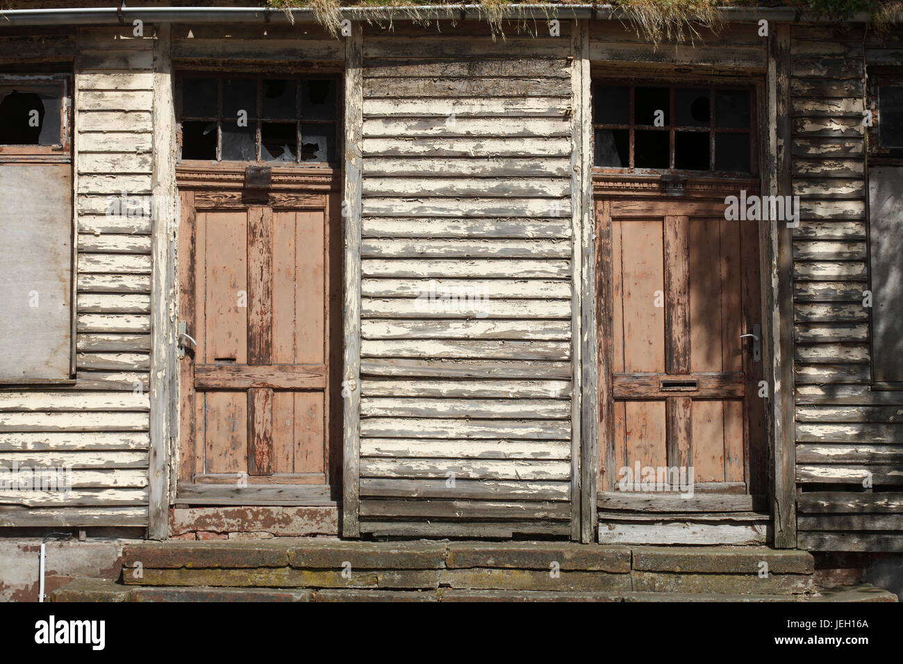 old doors on an old condemned wooden house Stock Photo - Alamy
