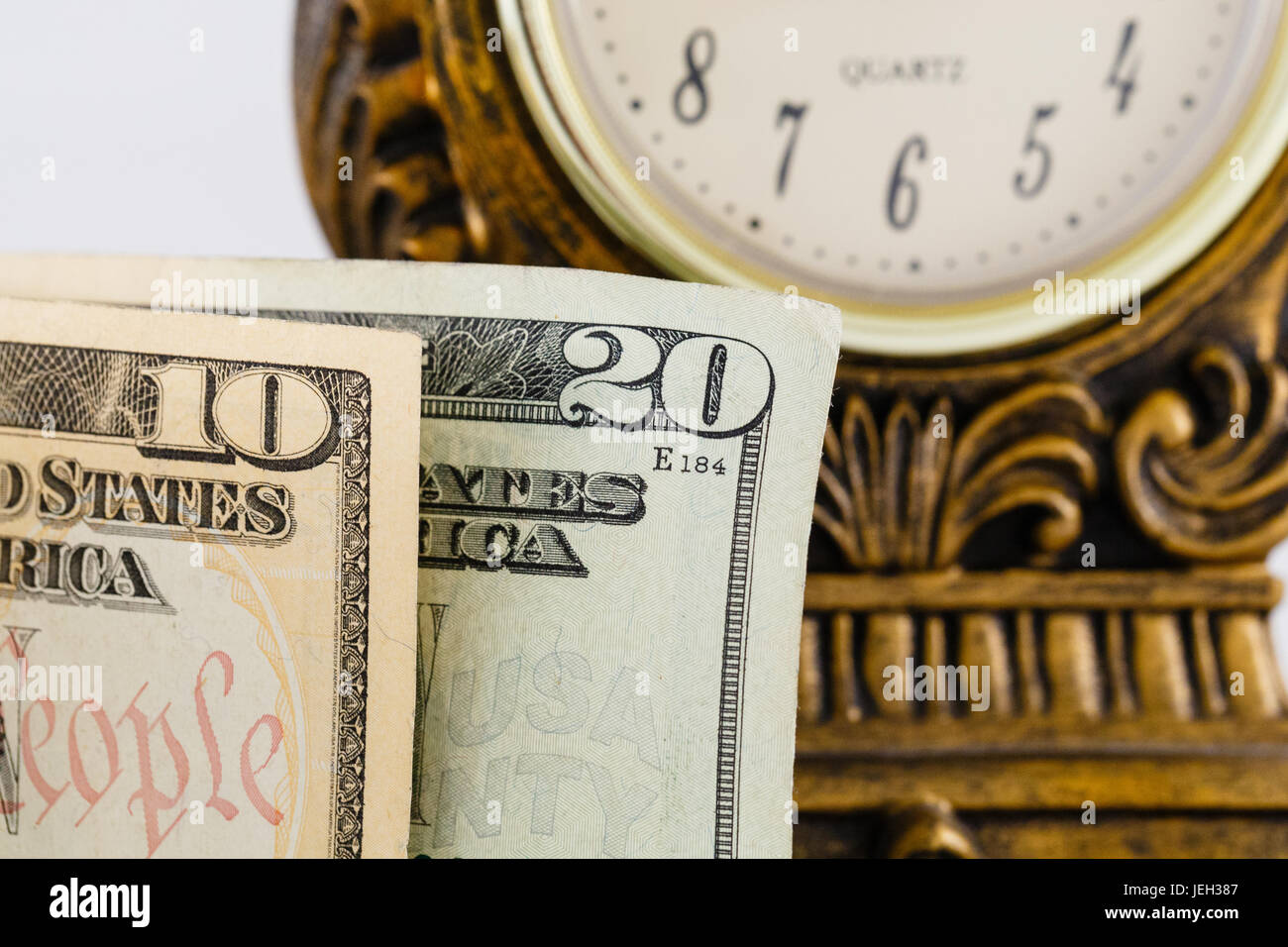 Close up of american cash money with a clock in the background Stock ...