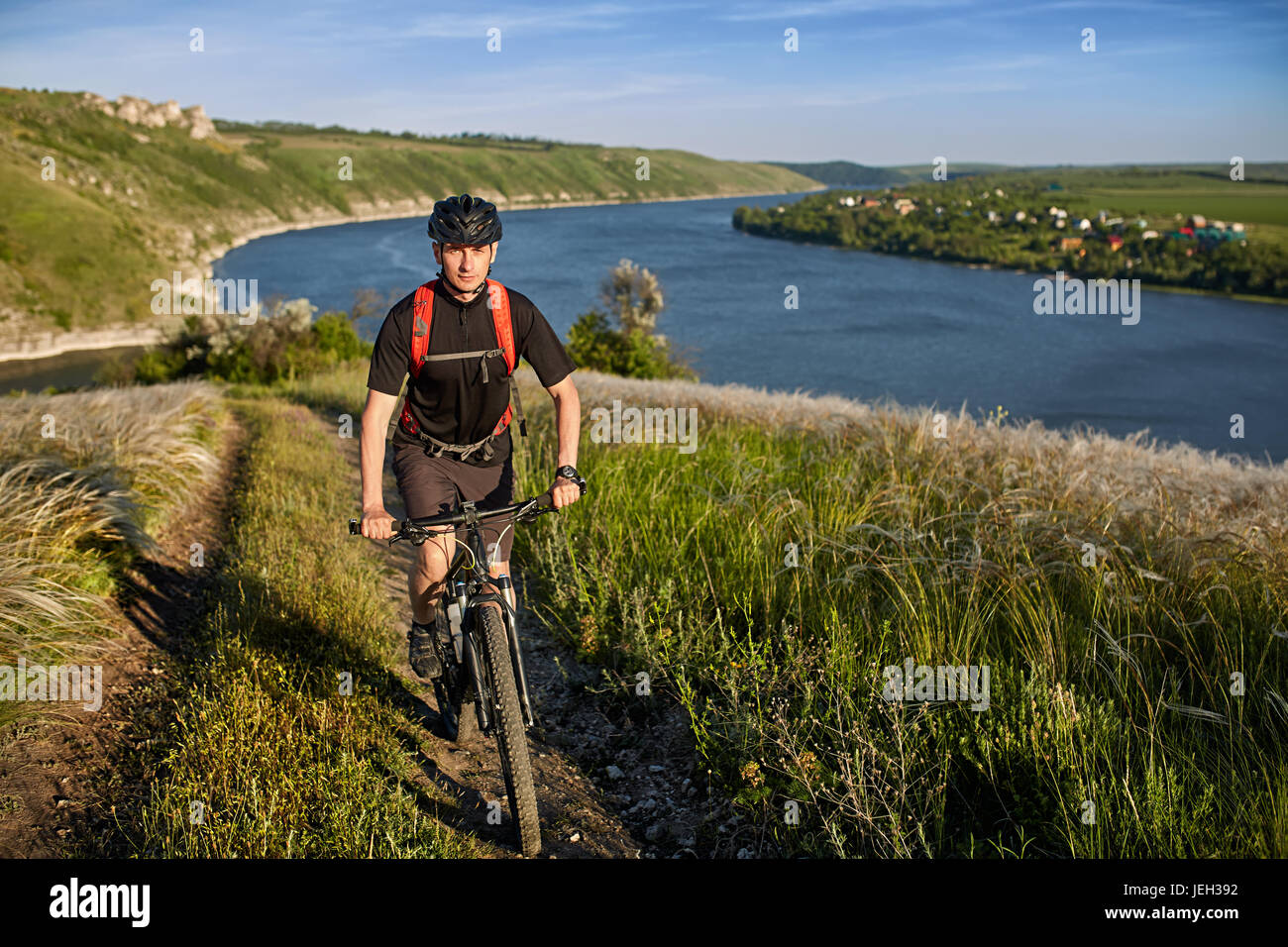 Person riding bike uphill hi-res stock photography and images - Alamy