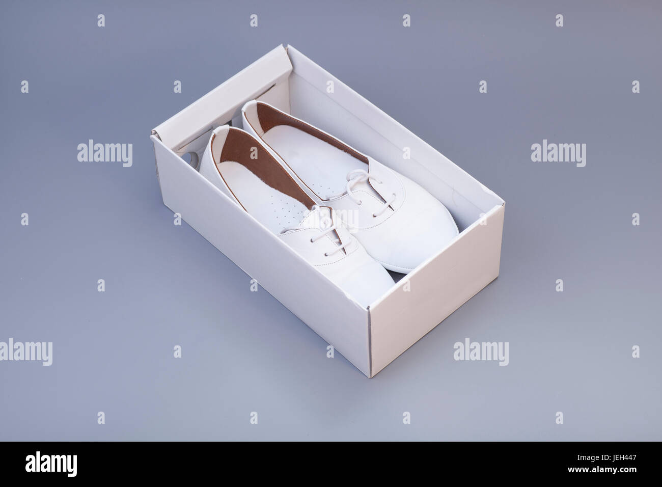 Pair of womans white shoes in box isolated on gray background Stock ...