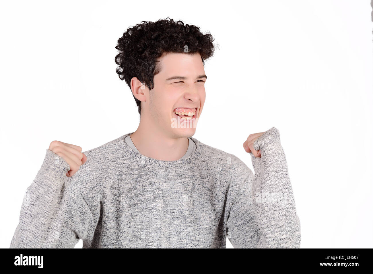 Portrait of a young latin man celebration victory. Isolated white ...