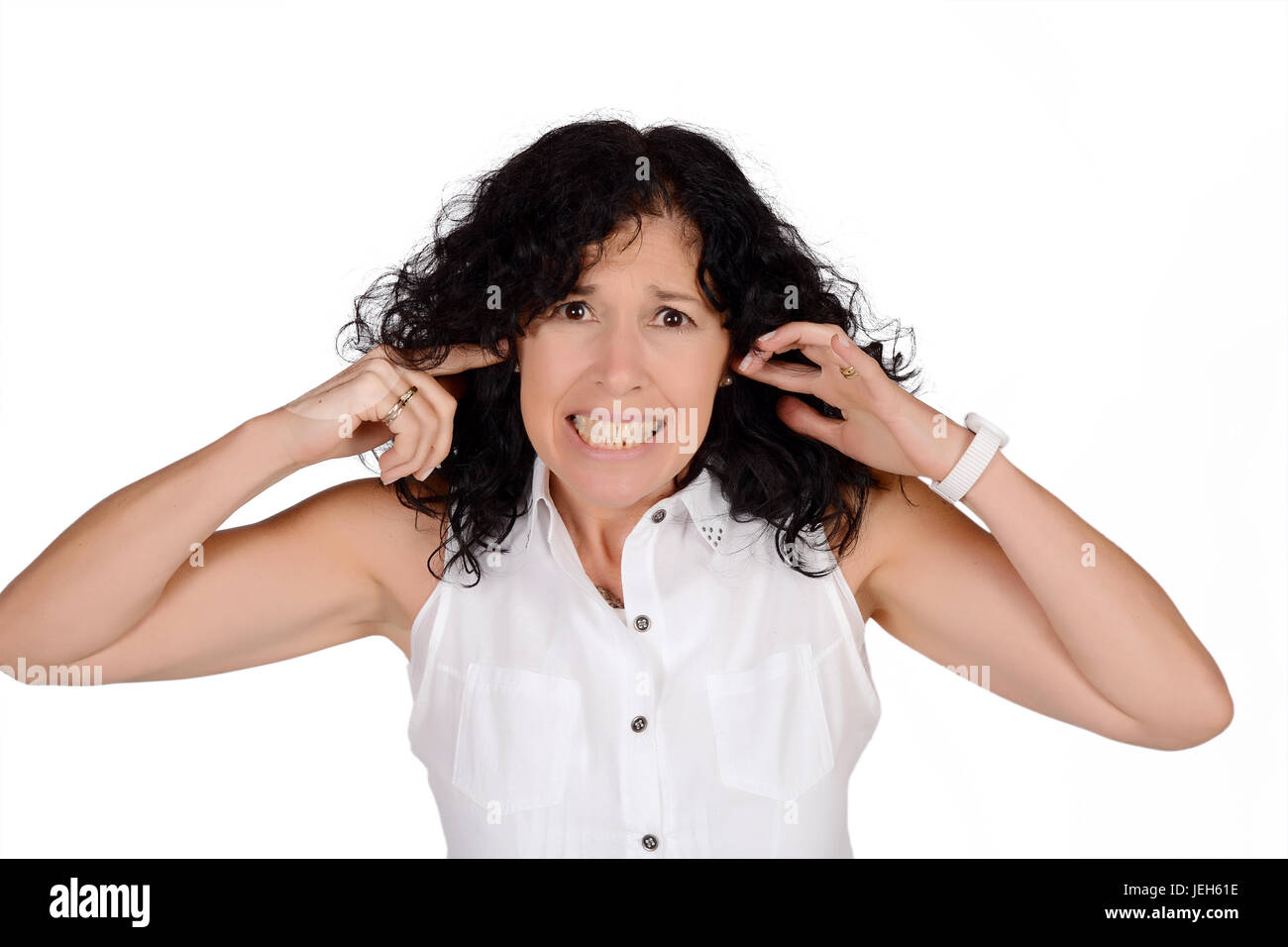 Portrait of a woman covering her ears. Isolated white background Stock ...
