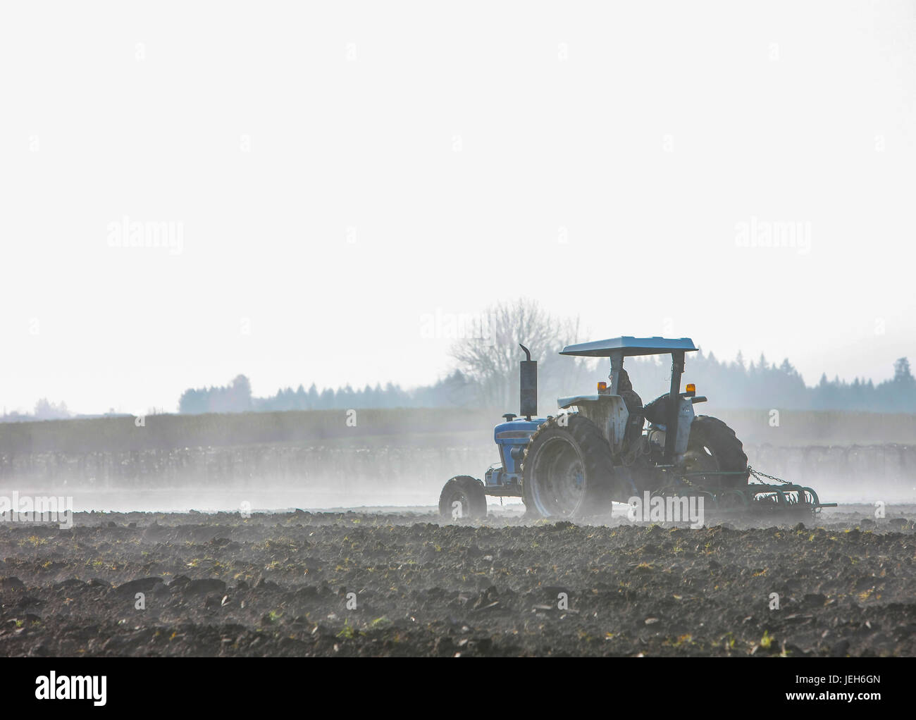 Farmer ploughing his field with a tractor hi-res stock photography and ...