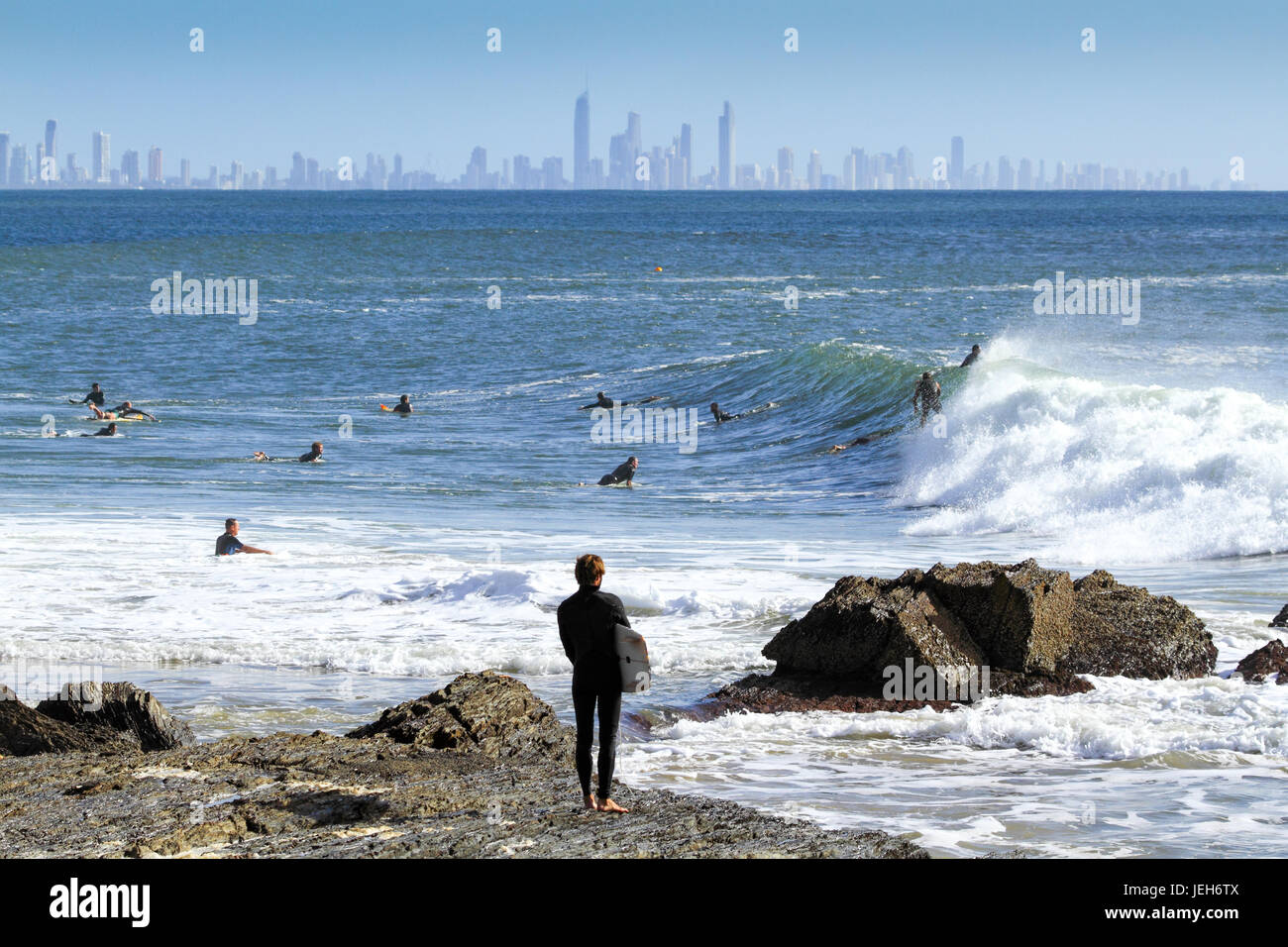 A man preparing to go surfing Stock Photo - Alamy