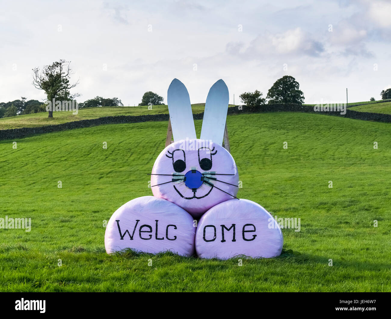 Wrapped hay bales decorated at a bunny rabbit and welcome sign ...